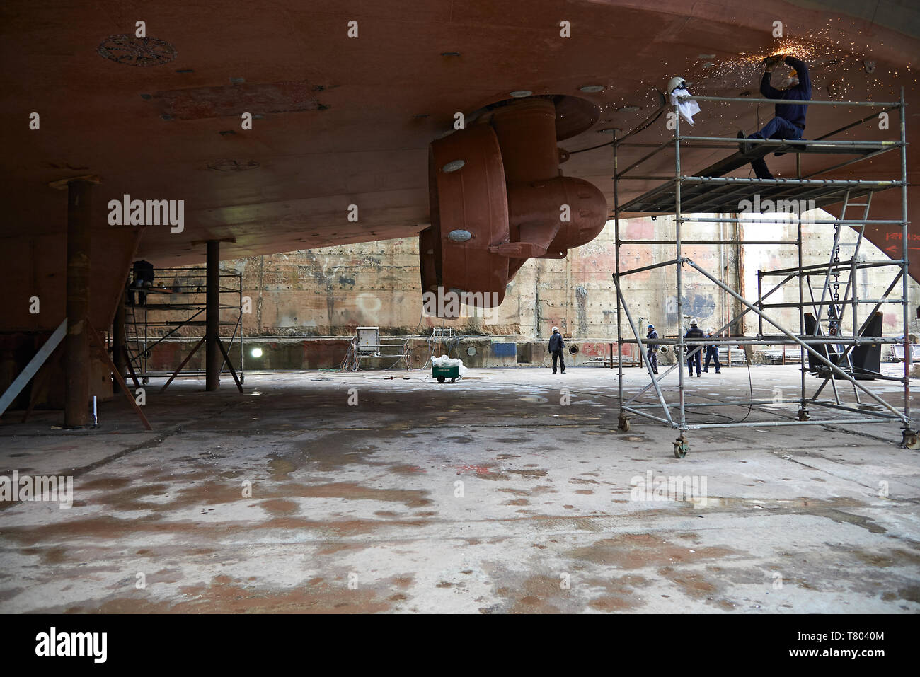 Labour shipping construction workers at the yard working on a new ship ...