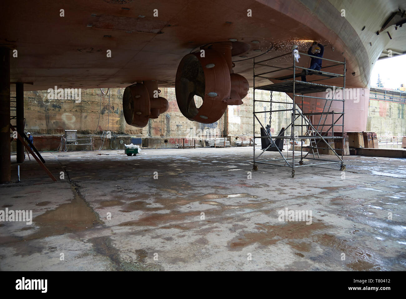 Labour shipping construction workers at the yard working on a new ship ...