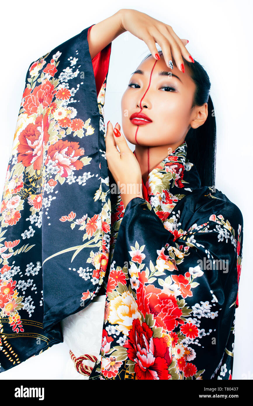 young pretty real geisha in kimono with sakura and decoration on white ...