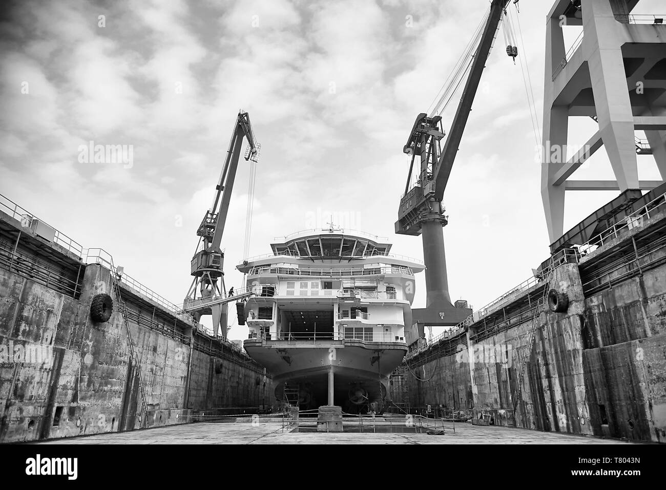 Labour shipping construction workers at the yard working on a new ship ...