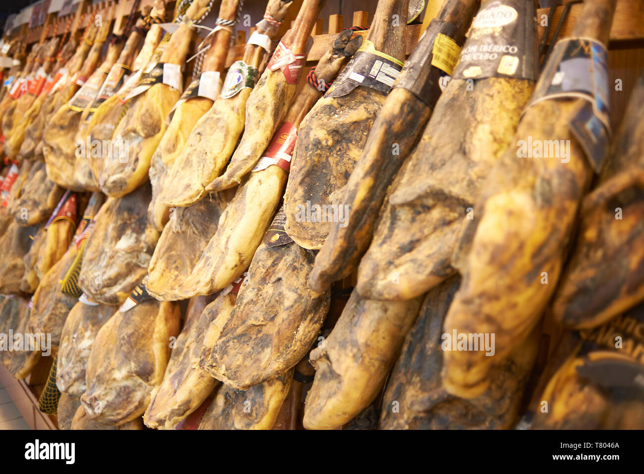 Dried cured meat hanging on a wall Stock Photo - Alamy