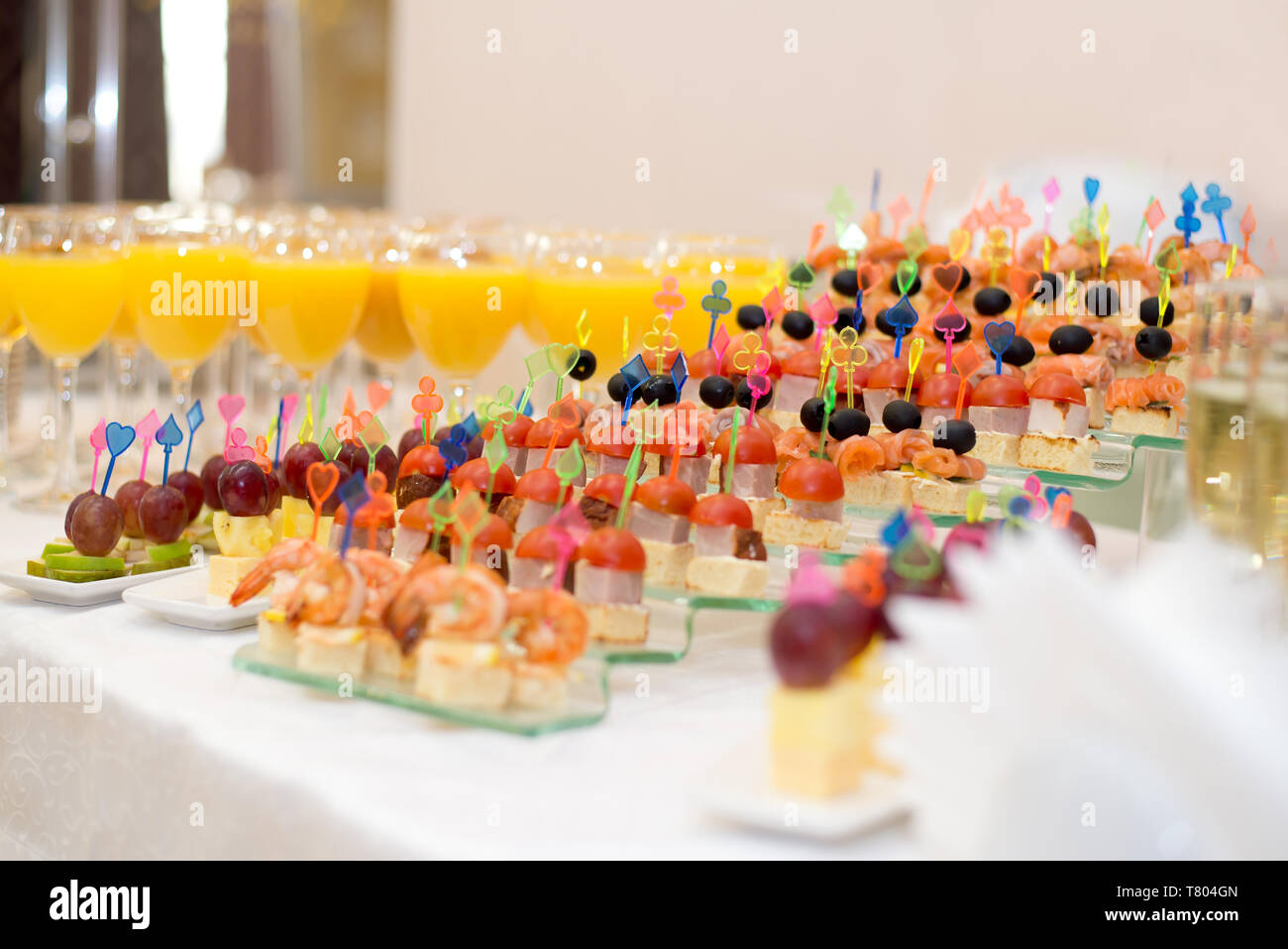 Delicious appetizer canapes with tomatoes, olives, ham on the festive ...