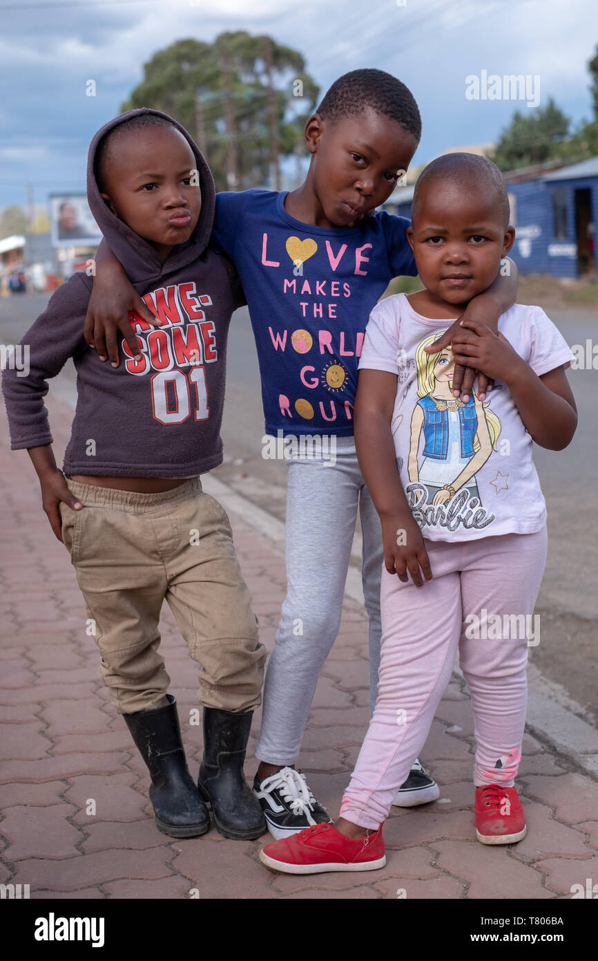 Young children pose for the camera on the main street in the town of ...
