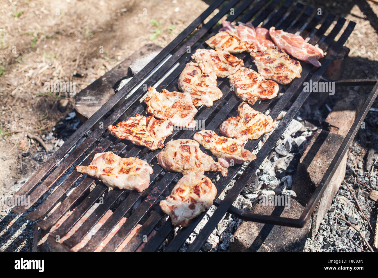 Grilled pork meat on barbecue outdoor Stock Photo - Alamy