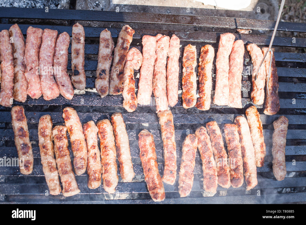 Handmade small rolled patty of ground meat on outdoor improvised ...