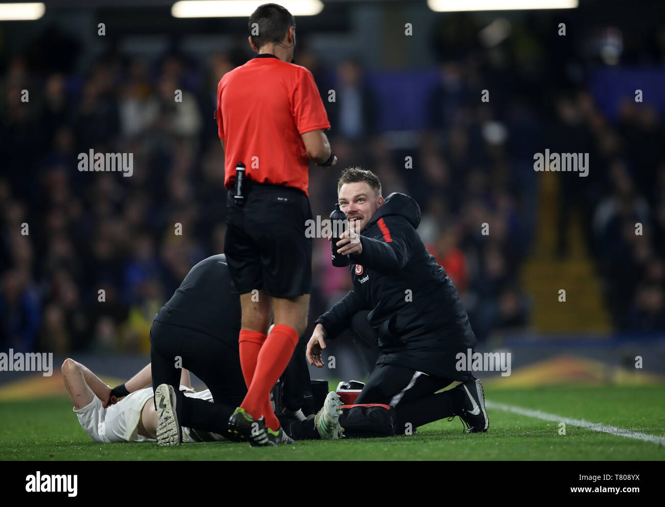 A Frankfurt Physio offers Referee Ovidiu Alin Hategan a drink during ...