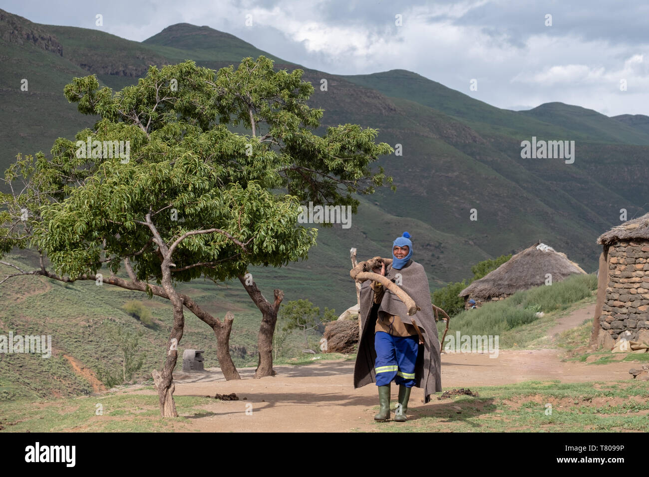 Shepherd wearing a blanket against the cold, in a mountain village near ...