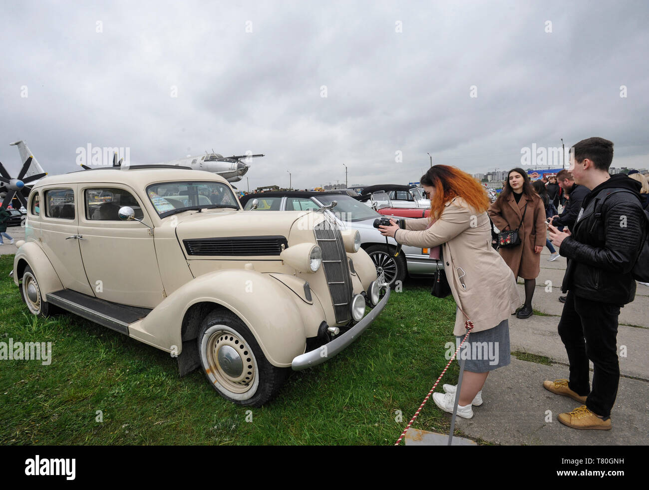 A woman seen taking pictures of the Dodge D2 car 1932 during the Old ...