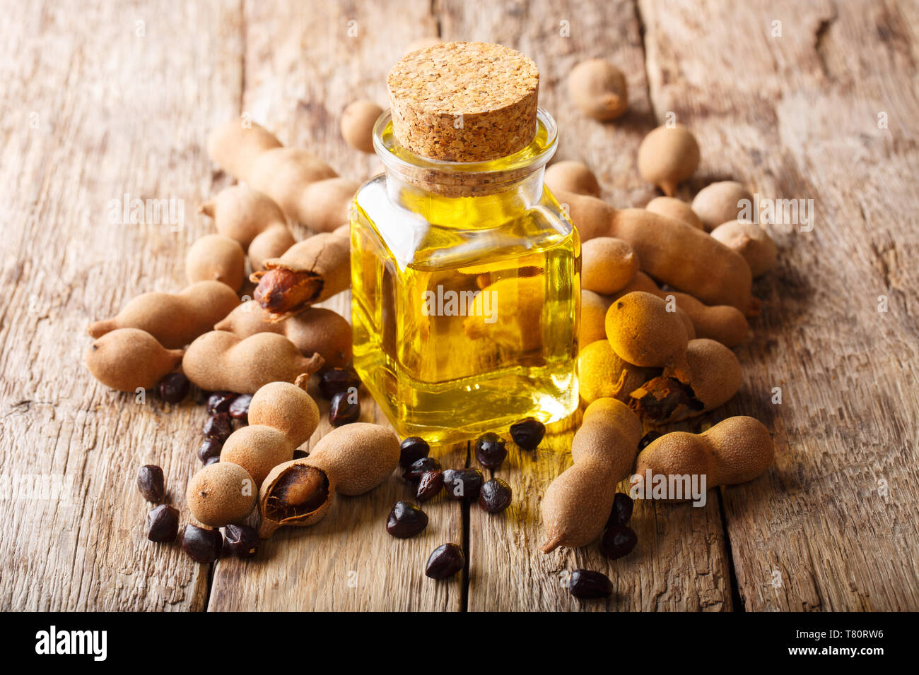 Tasty diet tamarind oil in a glass jar close-up on the table ...