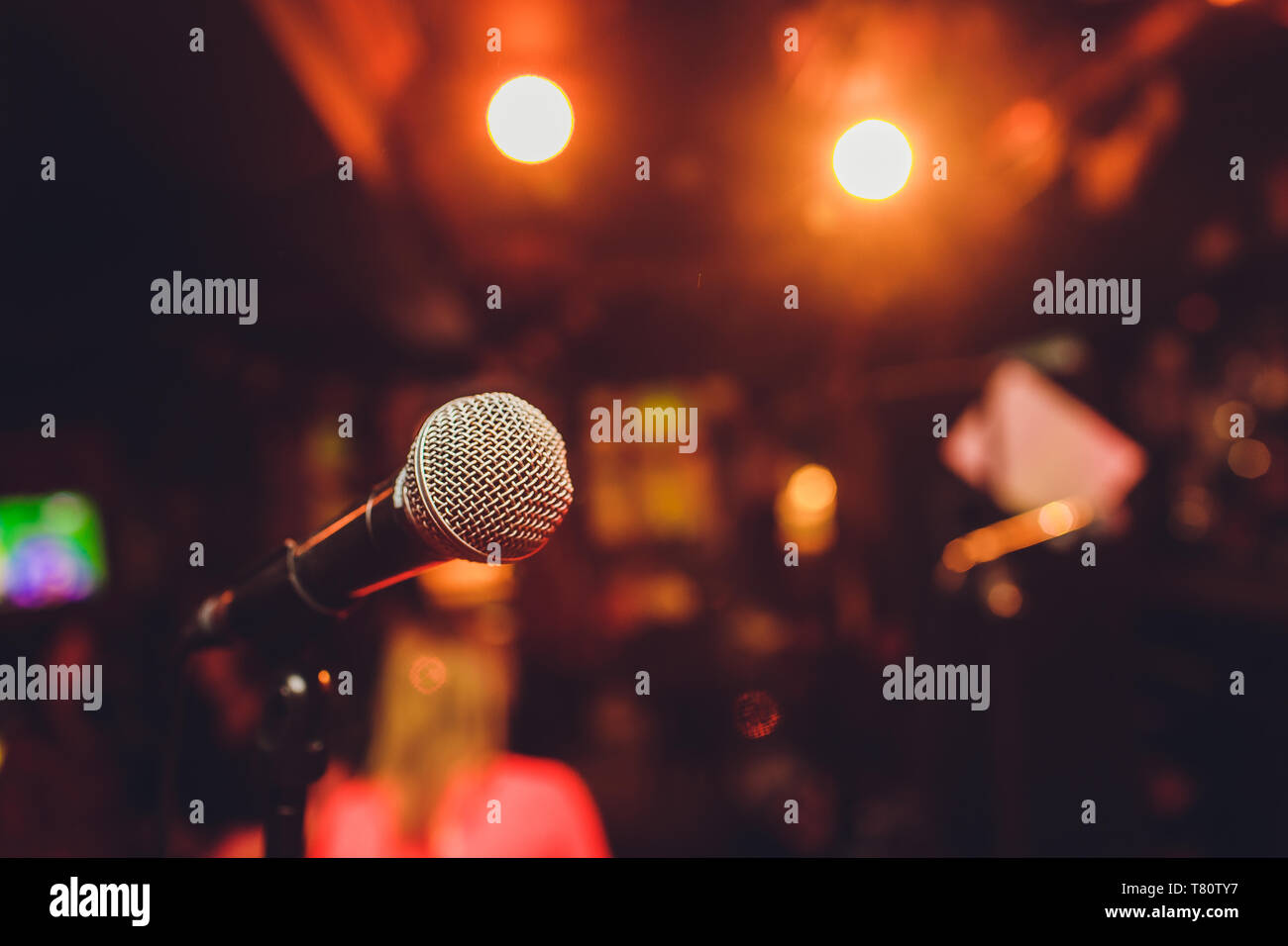 Microphone on stage against a background of auditorium Stock Photo - Alamy