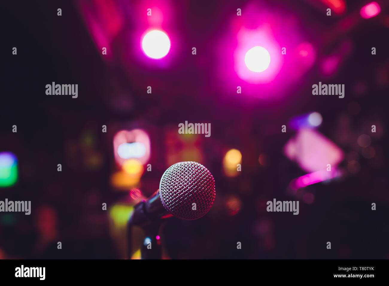 Microphone on stage against a background of auditorium Stock Photo - Alamy