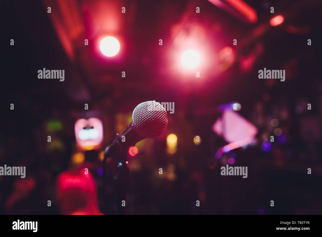 Microphone on stage against a background of auditorium Stock Photo - Alamy