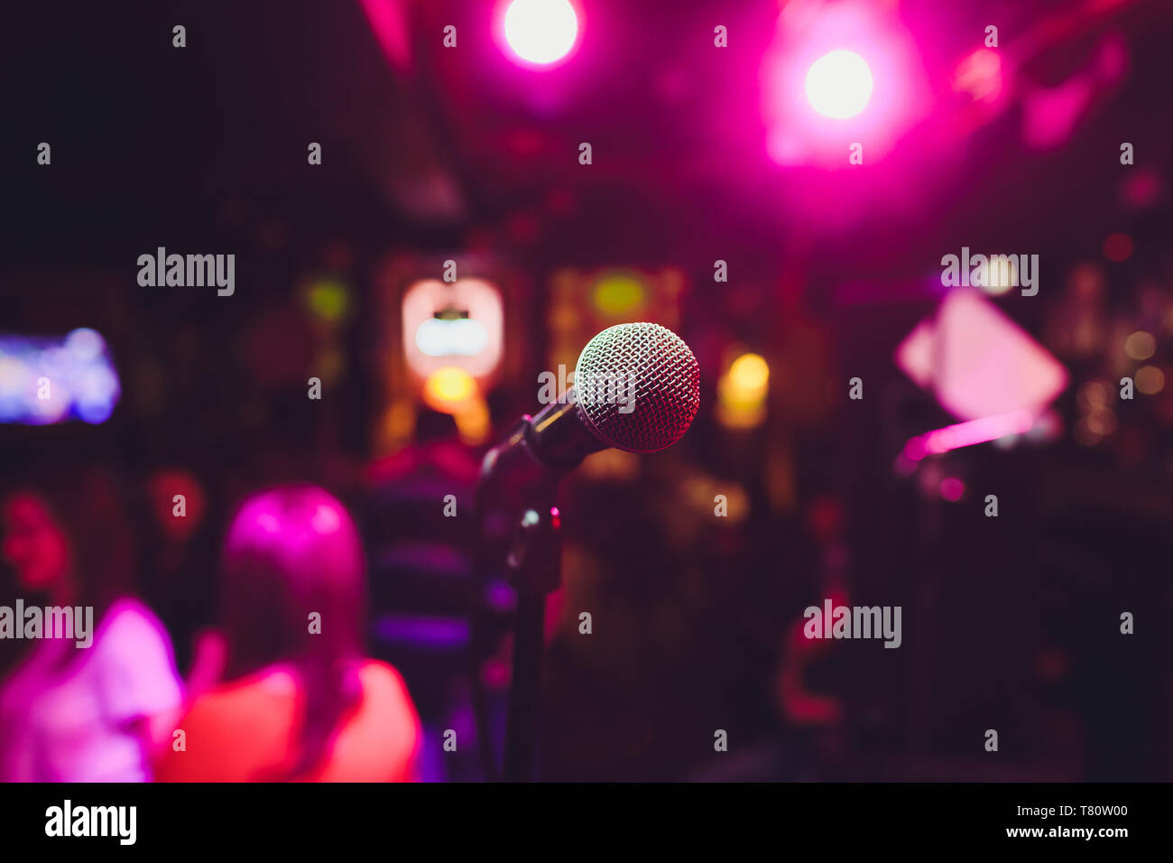 Microphone on stage against a background of auditorium Stock Photo - Alamy