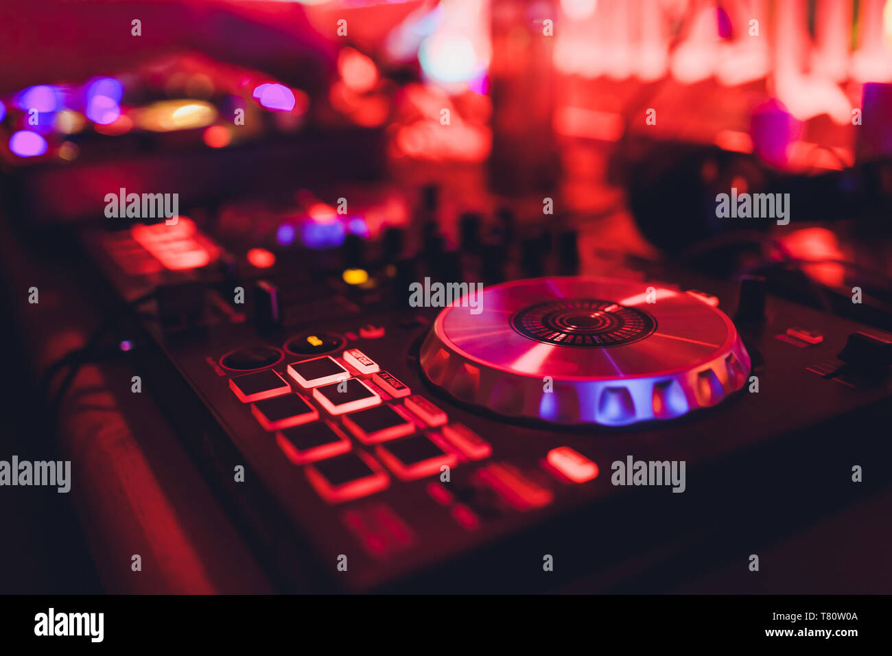 DJ turntable console mixer controlling with two hand in concert ...