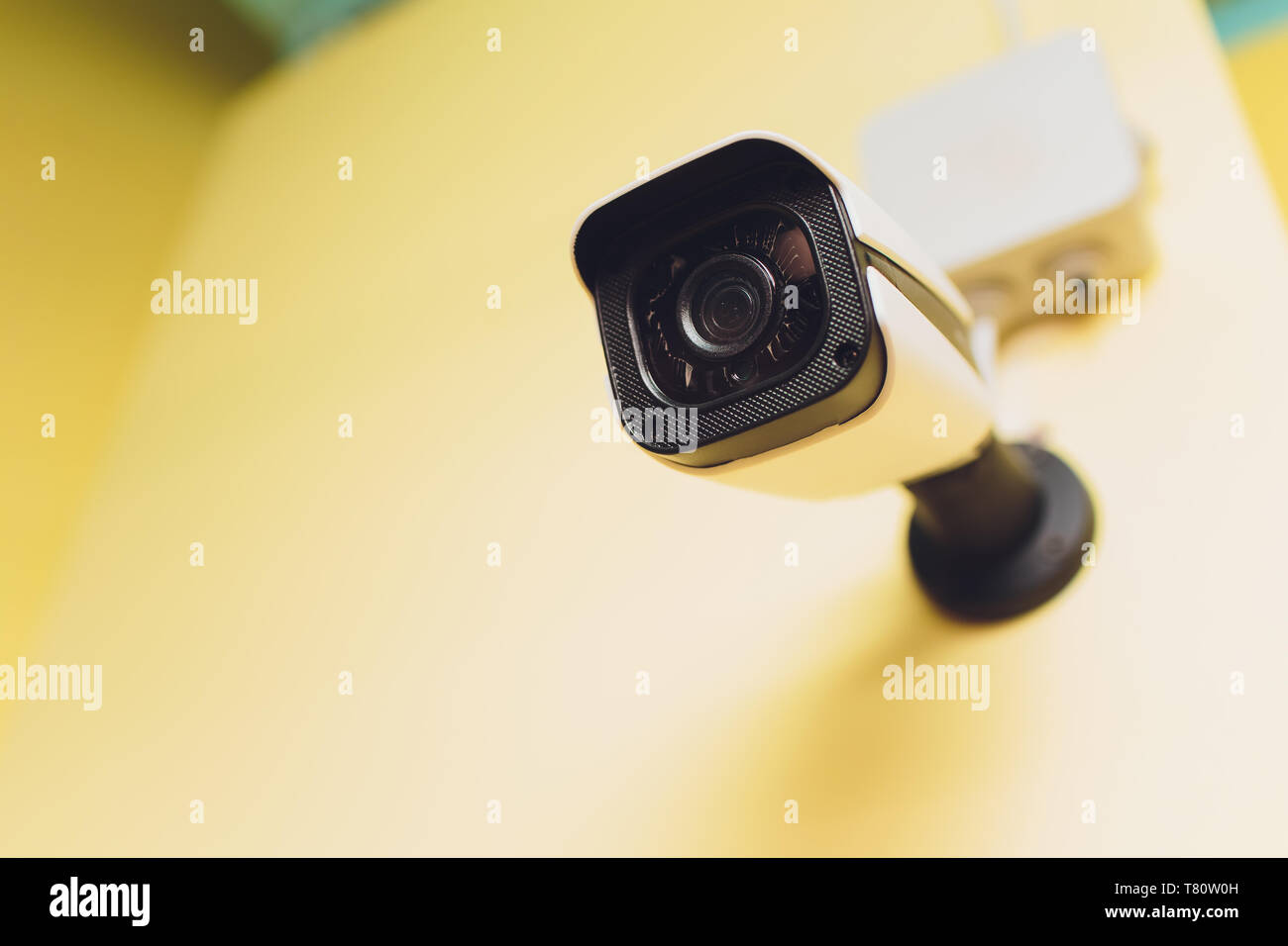 Security camera and motion detector installed on ceiling in room Stock ...