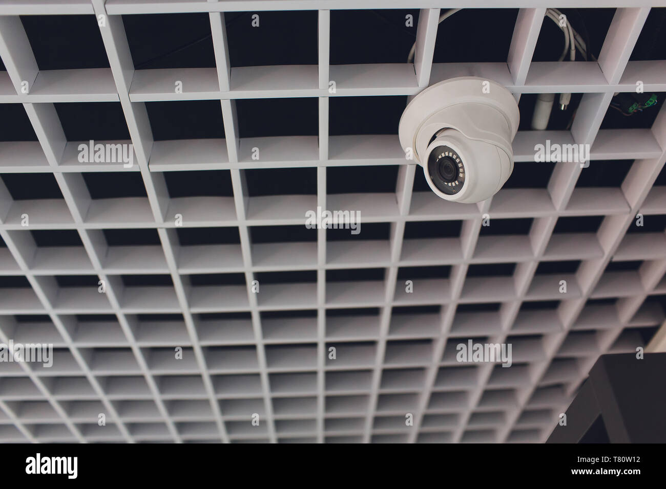 Security camera and motion detector installed on ceiling in room Stock ...