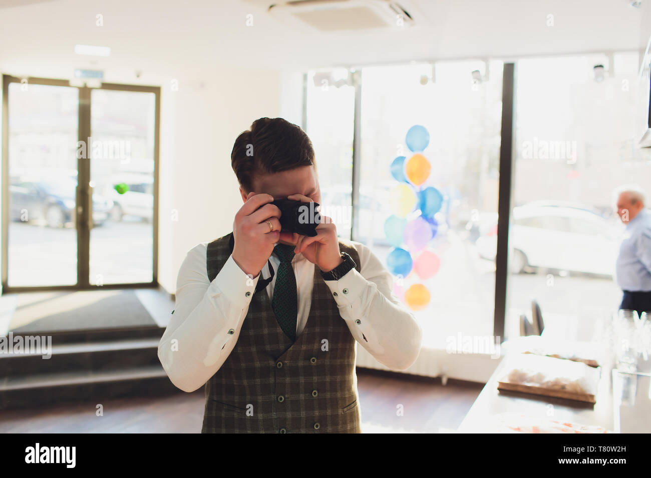 Man holding photo camera in hand outdoor, photographer concept ...