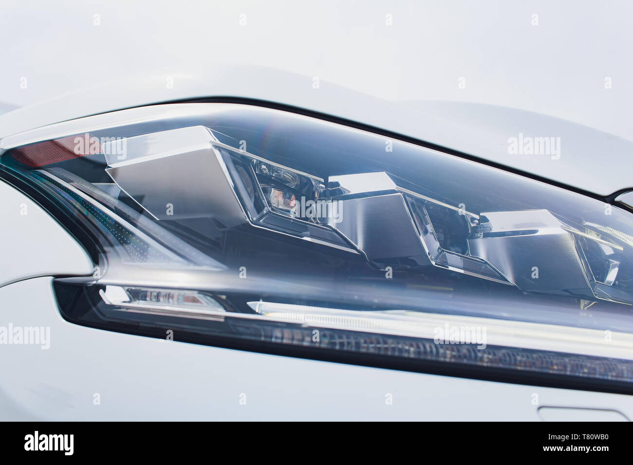 Close up of headlight detail of modern luxury car with projector lens ...