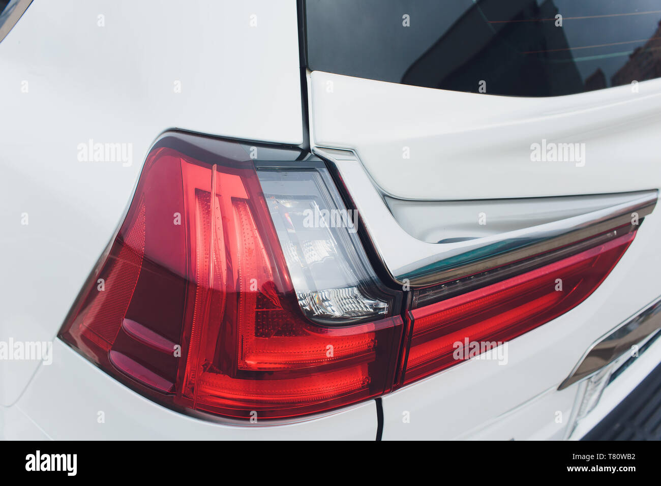 Close up of rear lights detail of modern luxury car with projector lens ...