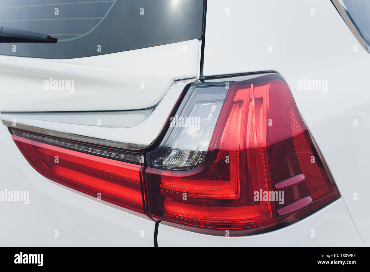 Close up of rear lights detail of modern luxury car with projector lens ...