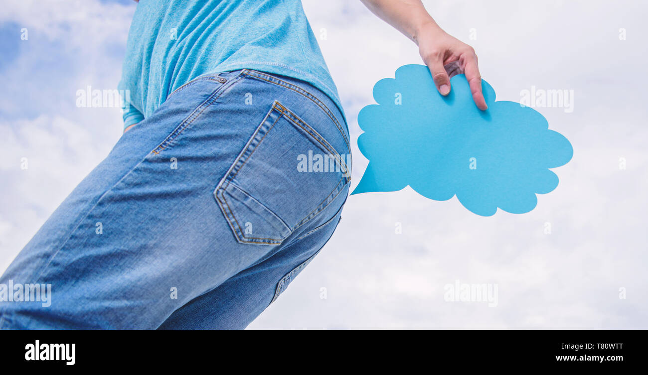 Man suffers from diarrhea. The guy is holding farting cloud near ass ...