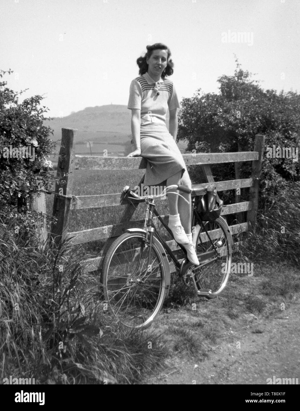 A young Woman Sitting on a gate by her bicycle c1938. Photo by Tony ...