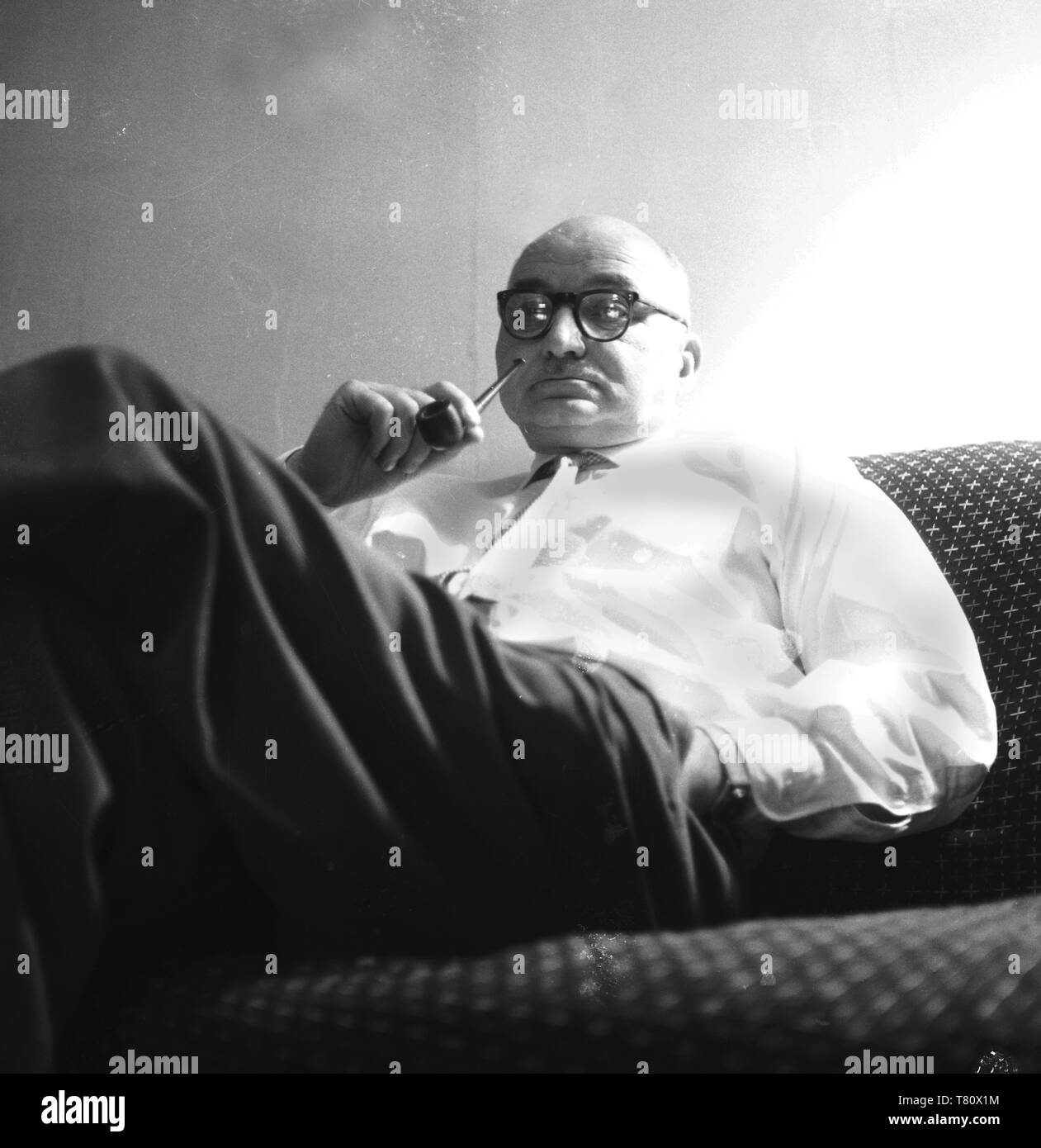 UK Family Life At Home in 1952 Portrait of a man at home on his settee ...