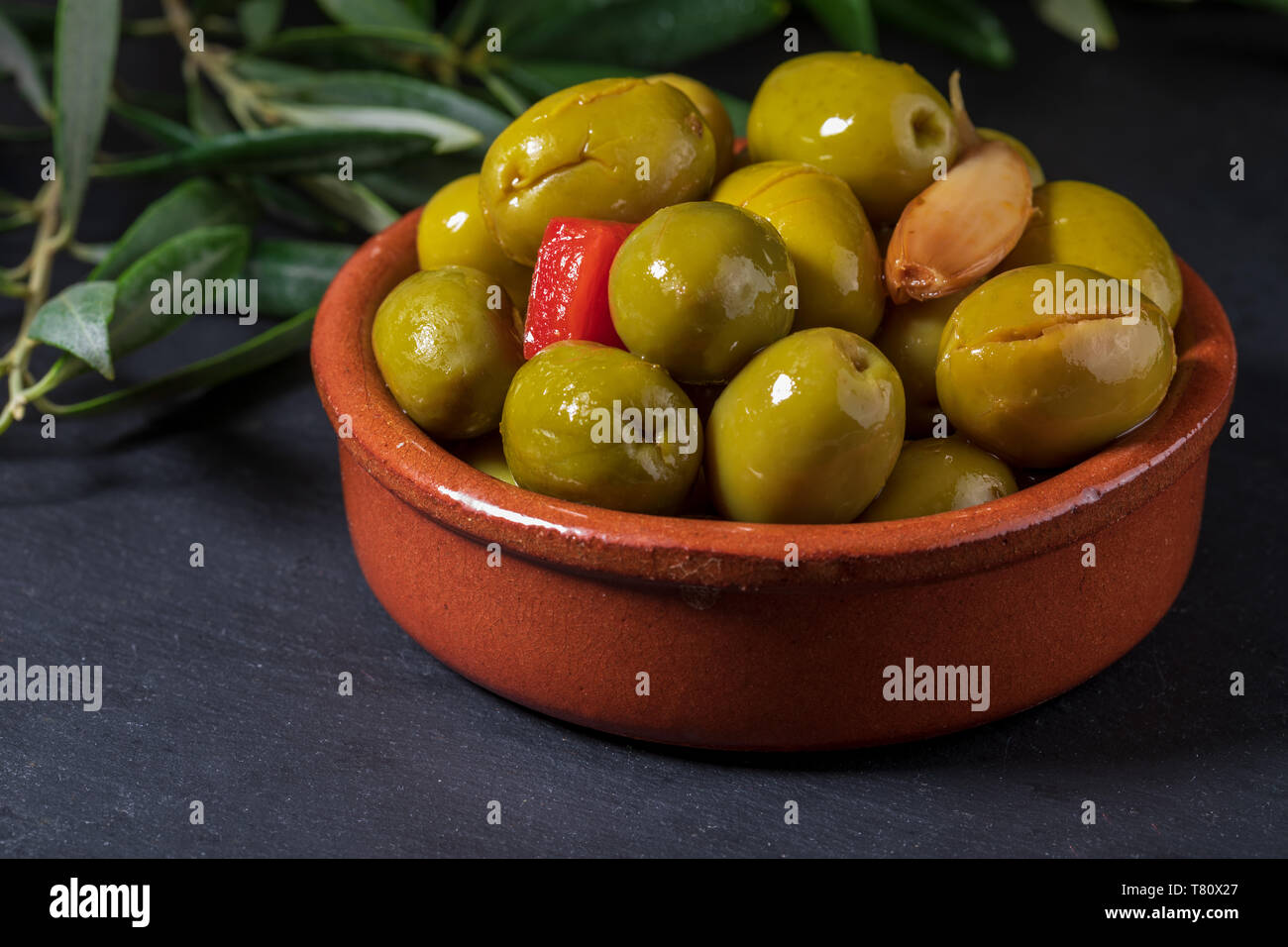 Clay pot with artisan olives (preserved in extra virgin olive oil ...