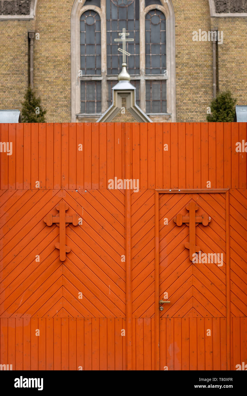 Church fence wooden gate in orange with crosses - image Stock Photo - Alamy