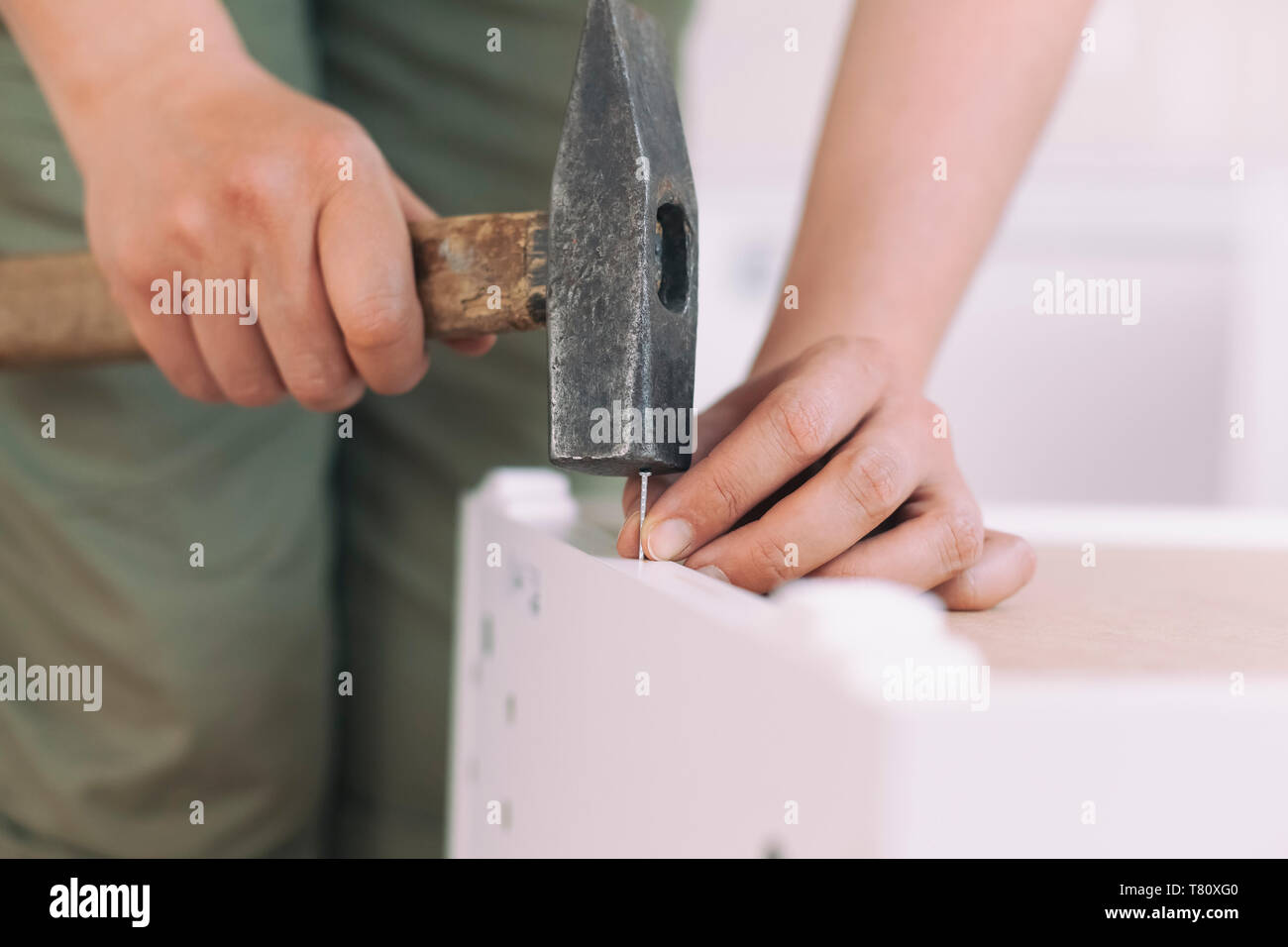 Woman hammer nail hi-res stock photography and images - Alamy