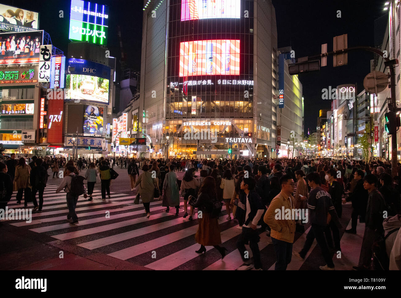 Neon signs above crowds at the Shibuya Crossing in Tokyo, Japan, Asia ...