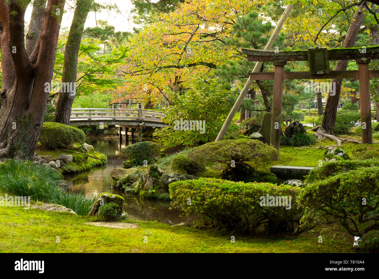 Hanambashi Bridge and a stone gate surrounded by autumn foliage in the ...