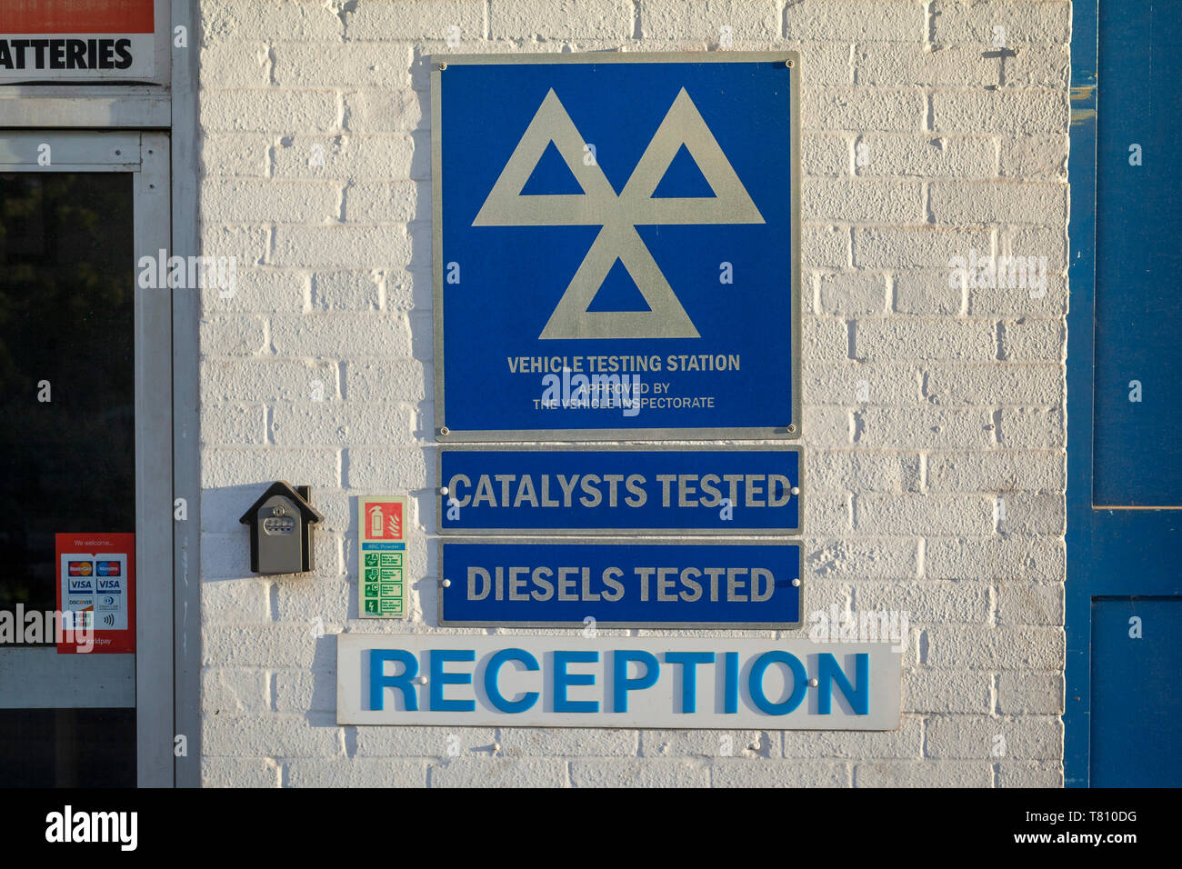 Blue and white signs for MOT vehicle testing station, catalysts tested ...