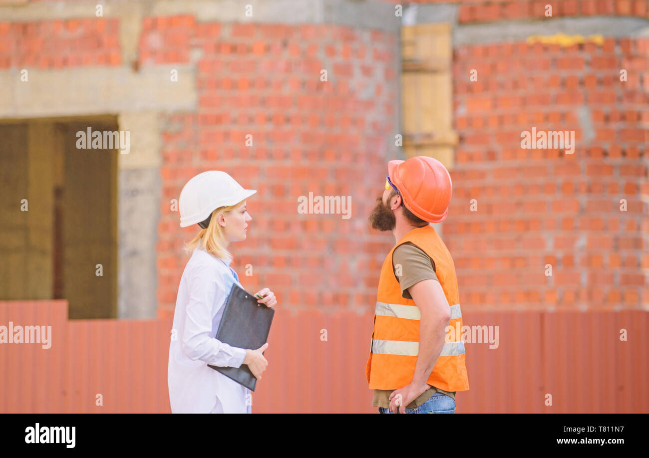 Discuss progress project. Construction industry concept. Woman engineer ... Discuss progress project. Construction industry concept. Woman engineer ...