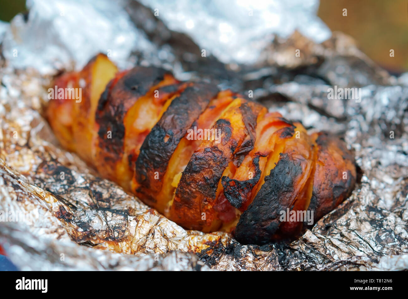 baked potatoes, vegetables baked in foil on fire Stock Photo - Alamy