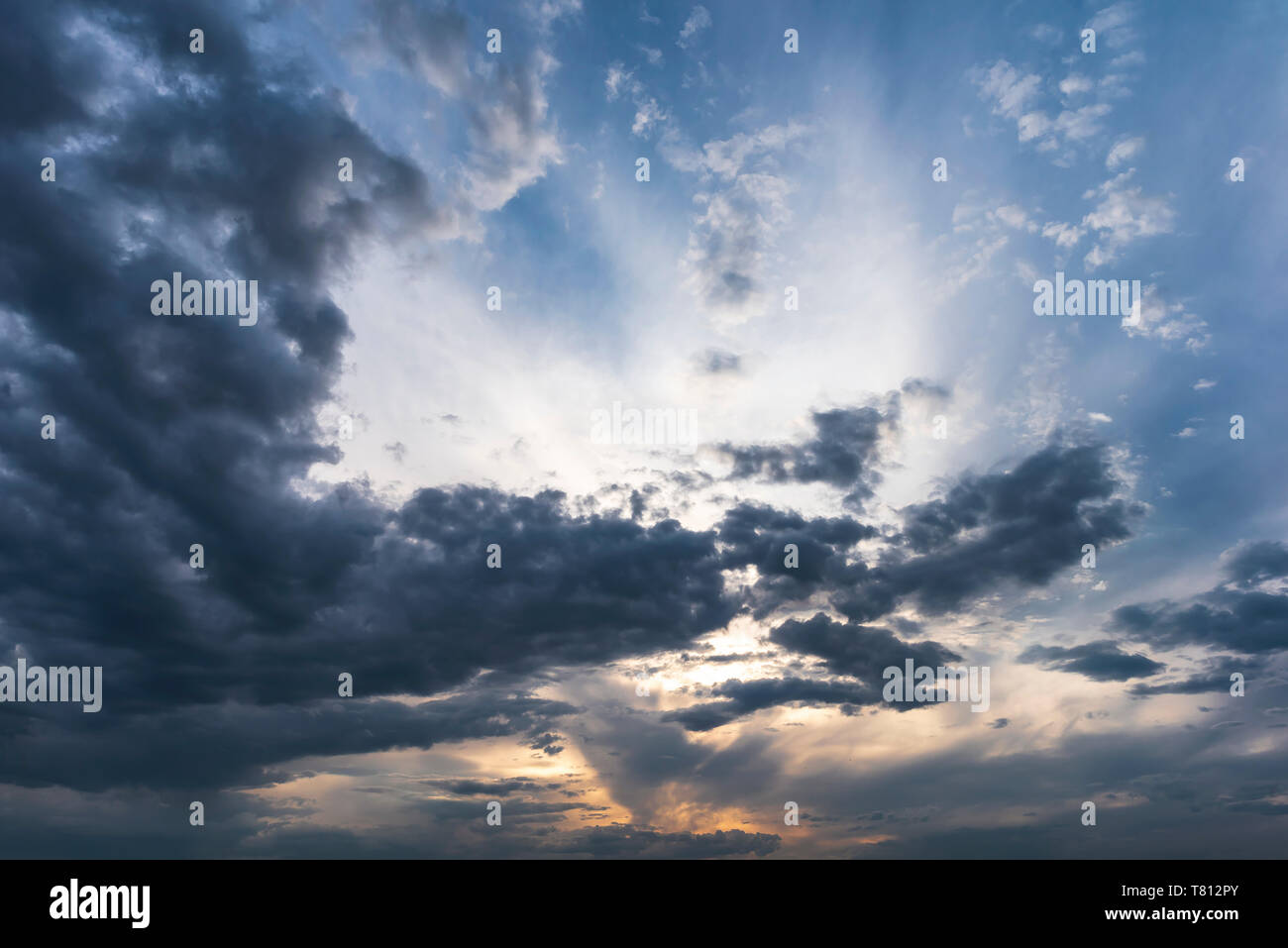Sunset behind dark grey clouds on sky Stock Photo - Alamy