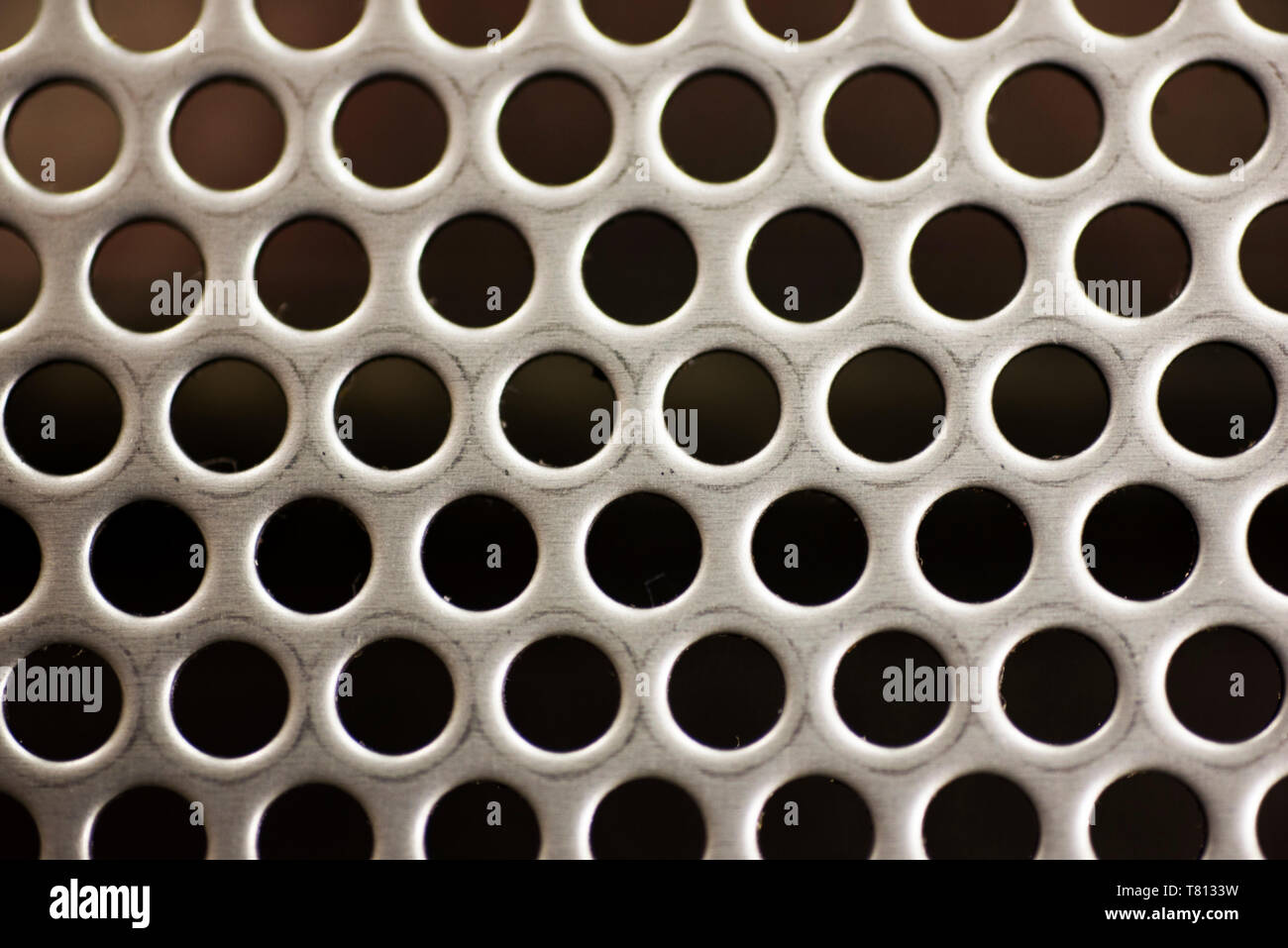 Metallic mesh with circular holes, background Stock Photo - Alamy