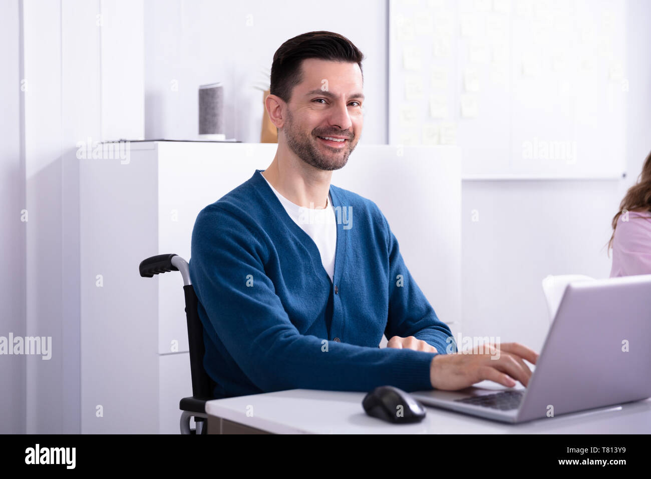 Man sitting desk in wheelchair hi-res stock photography and images - Alamy