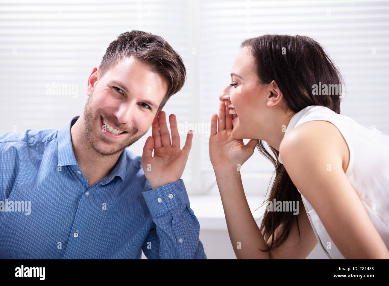Man whispering in woman ear hi-res stock photography and images - Alamy
