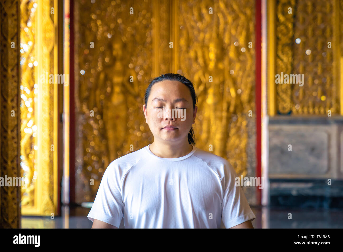 Asian long hair man relaxes meditation with all white costume sit in ...