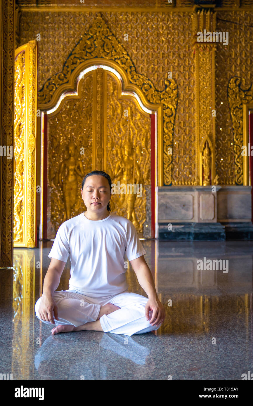 Asian long hair man relaxes meditation with all white costume sit in ...