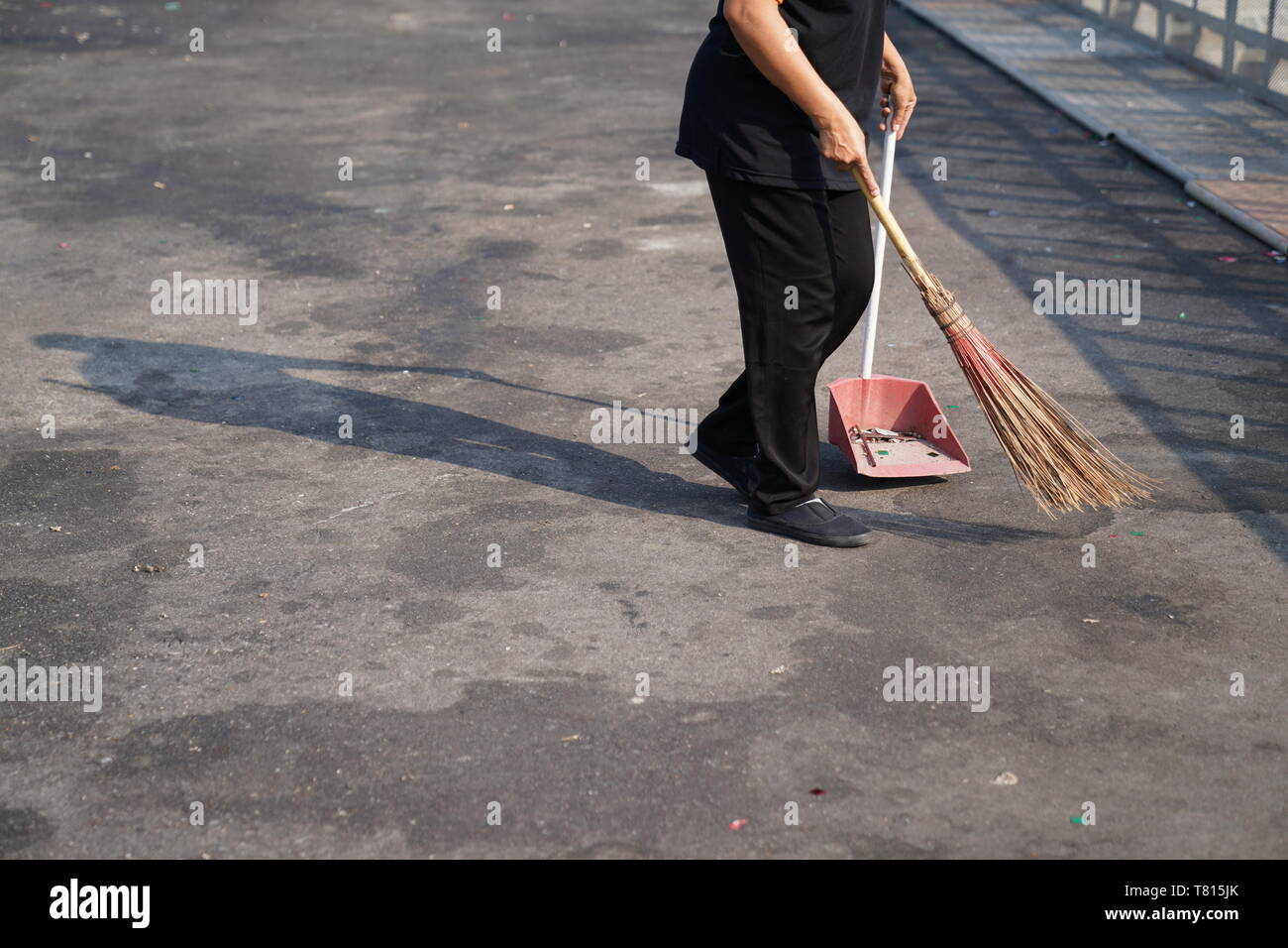 cleaner sweep trash in large asphalt outdoor area at noon Stock Photo ...