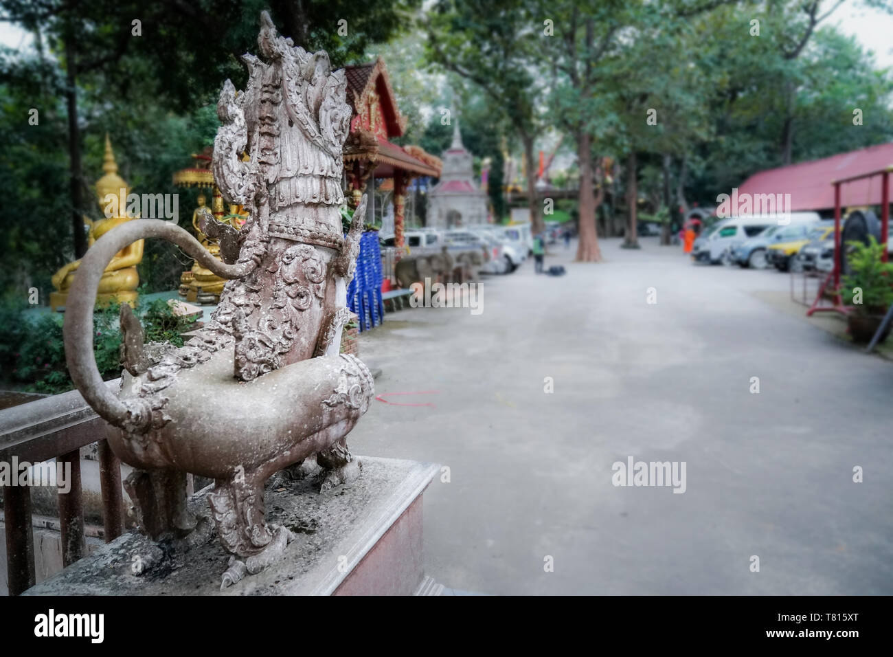 backside Asia ancient stone lion statue standing on the step to protect ...