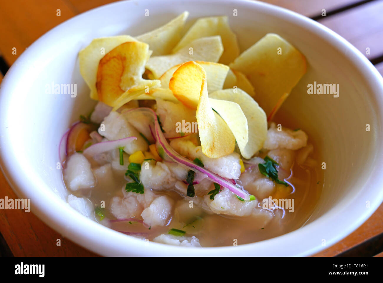 Raw fish ceviche with plantain chips Stock Photo - Alamy