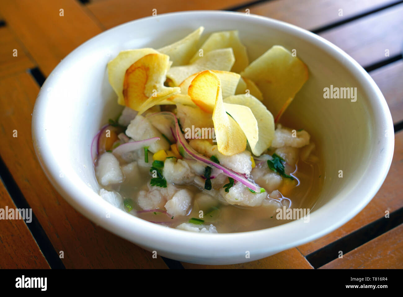 Raw fish ceviche with plantain chips Stock Photo - Alamy
