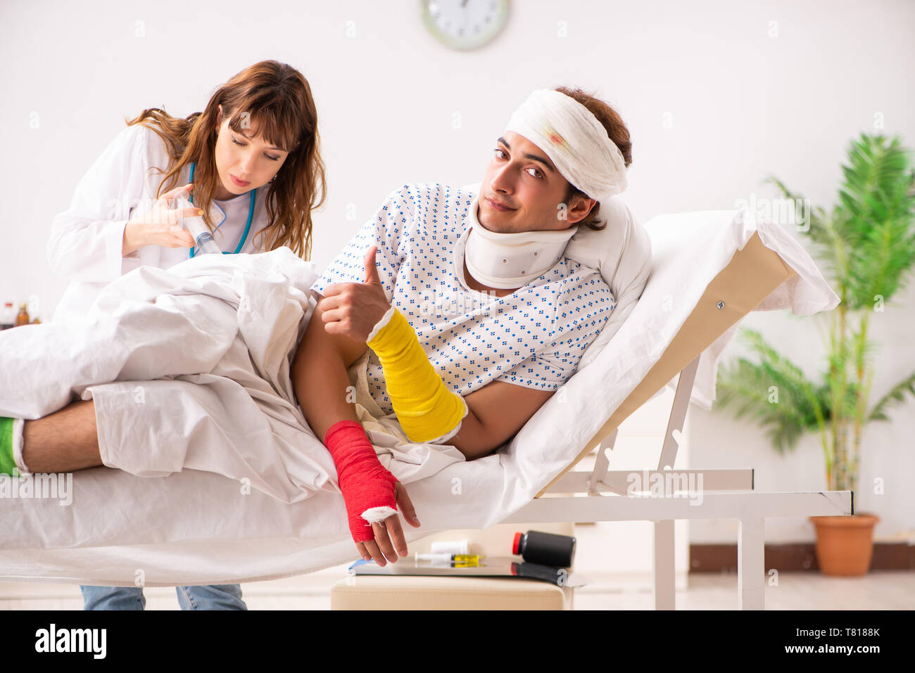 Young doctor examining injured patient Stock Photo - Alamy