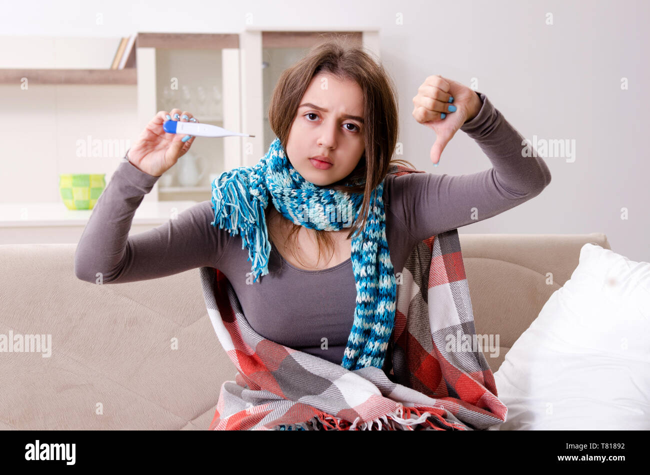 Sick upset woman measuring temperature hi-res stock photography and ...