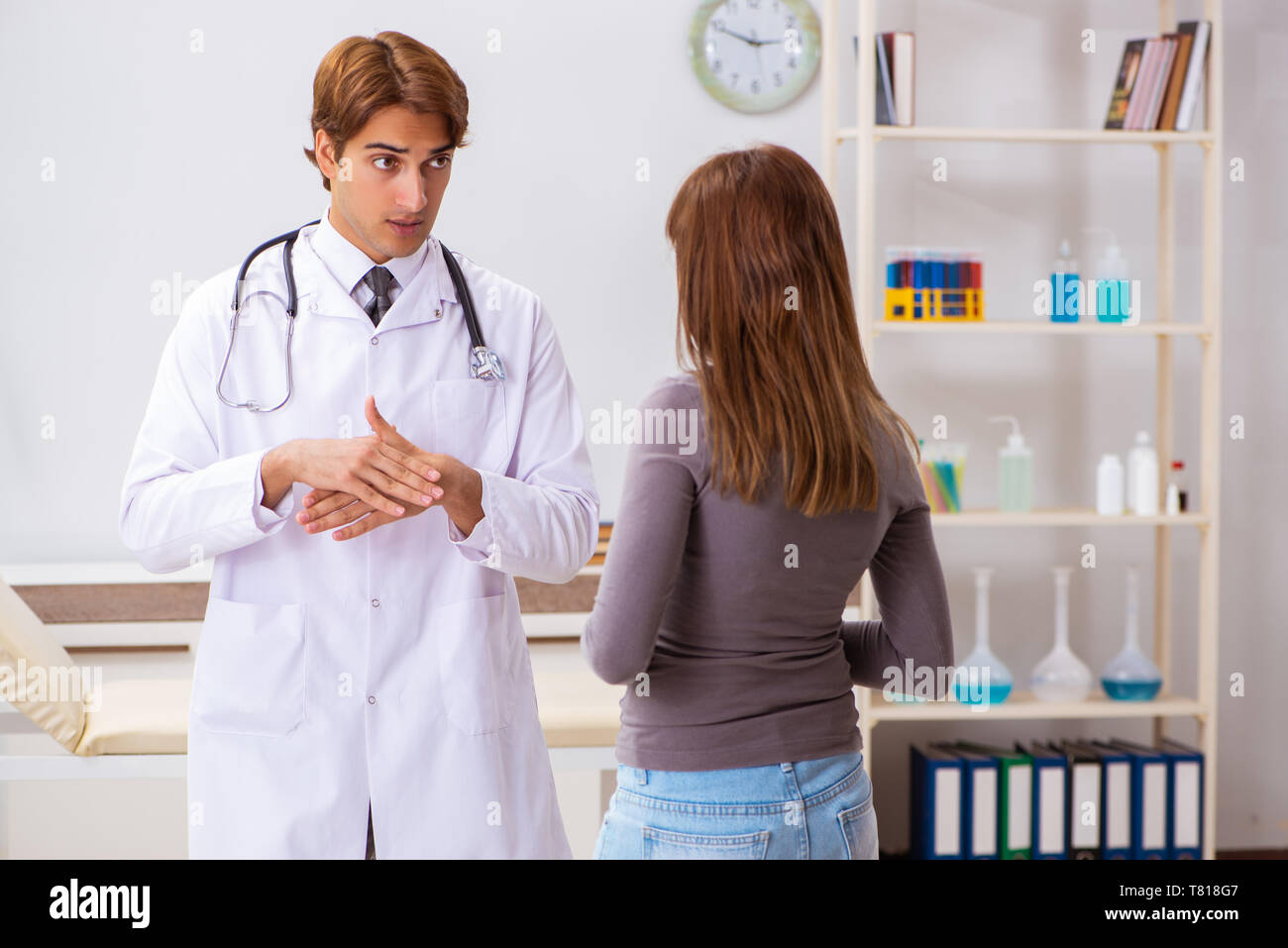 Deaf-mute female patient visiting young male doctor Stock Photo - Alamy