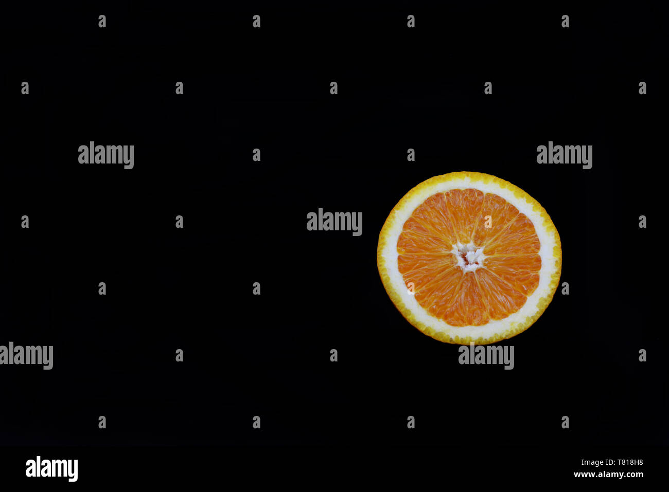 half ripe orange fruit useful on an isolated black background Stock ...