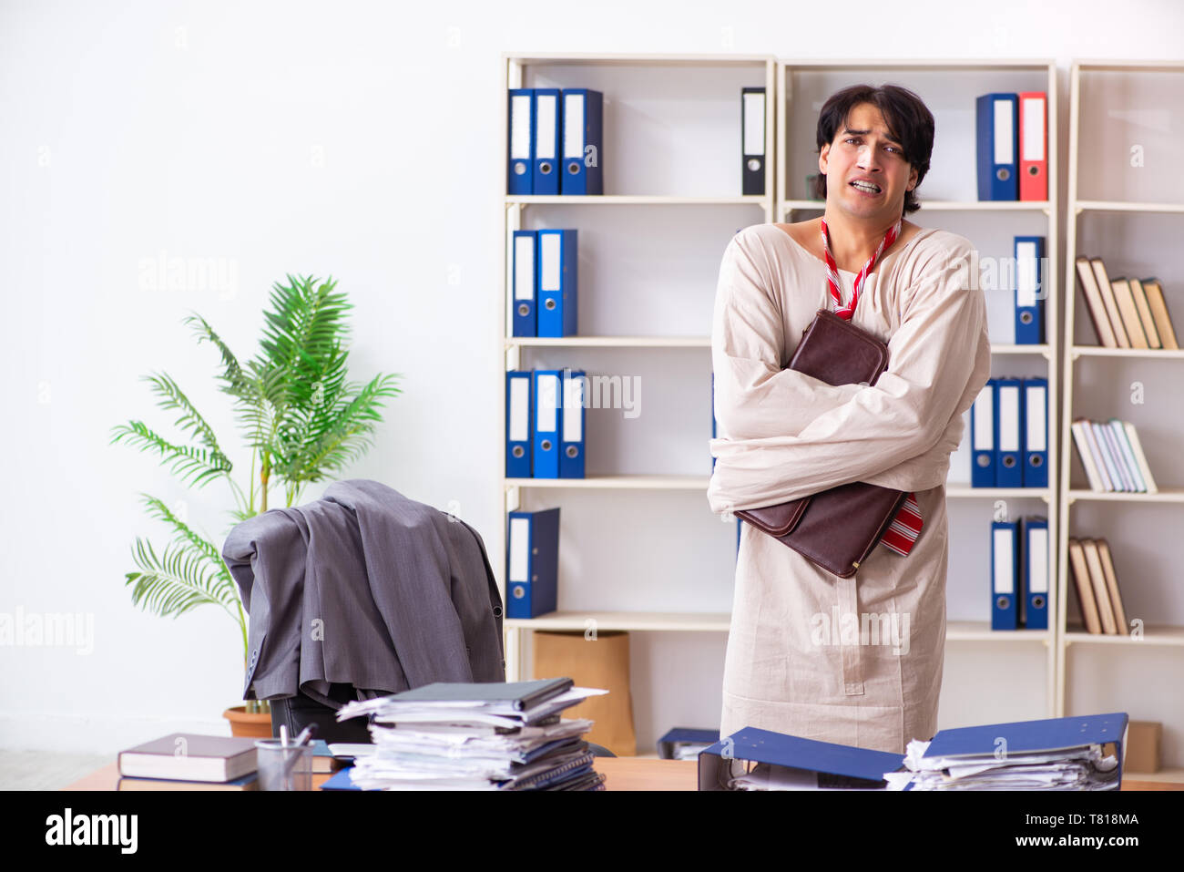 Crazy young man in straitjacket at the office Stock Photo - Alamy